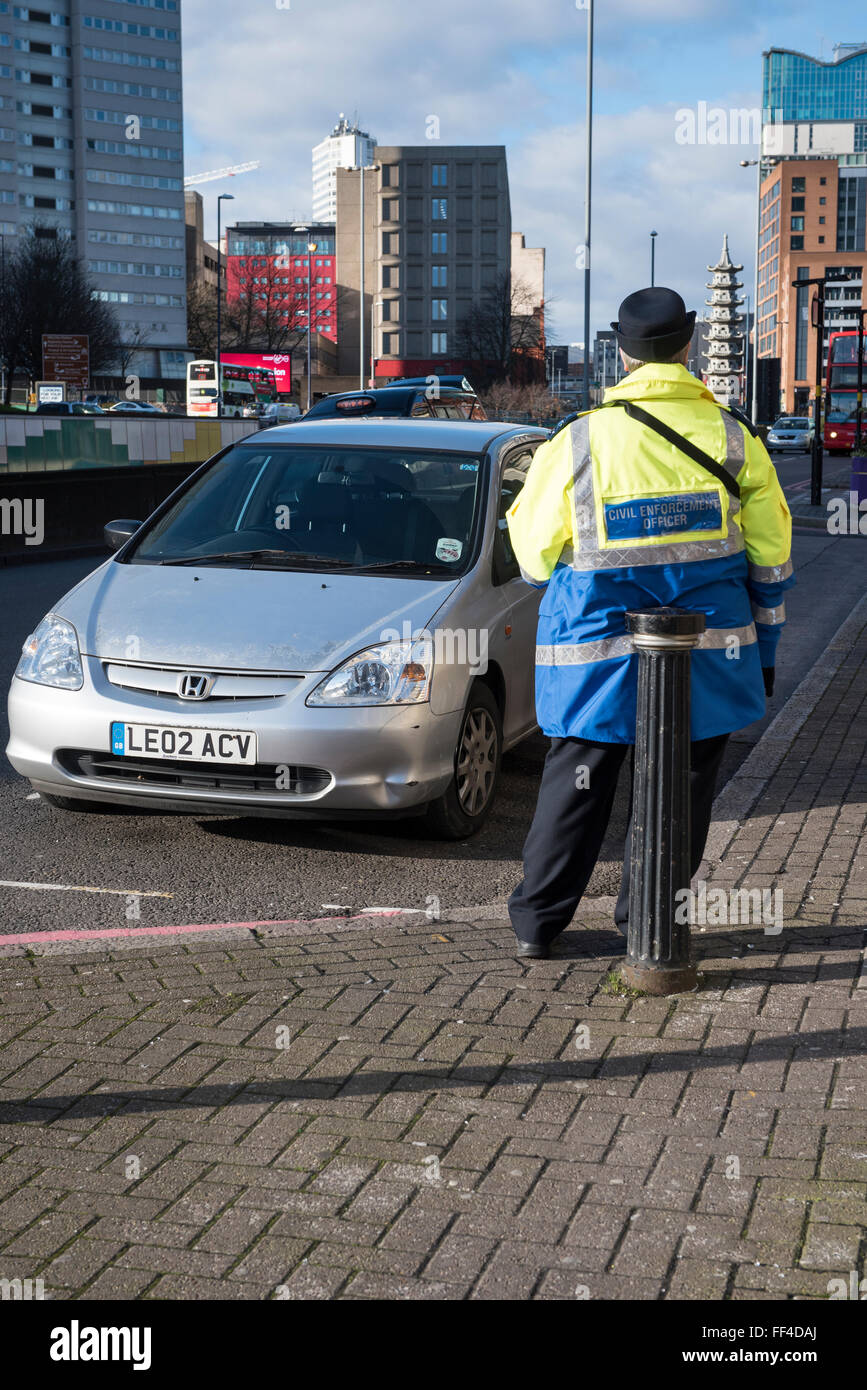 Civil enforcement officer waits by illegally parked car Stock Photo - Alamy