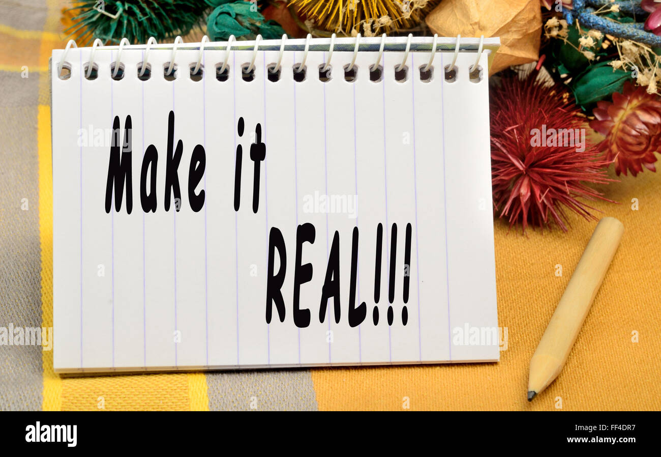 Make it real written on notebook Stock Photo - Alamy