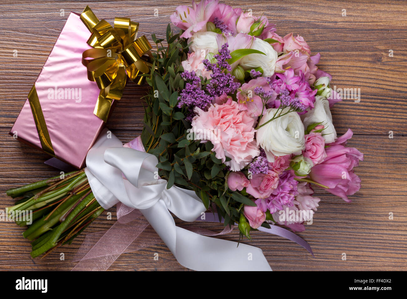 Valentine gift box with flowers on wooden background Stock Photo - Alamy