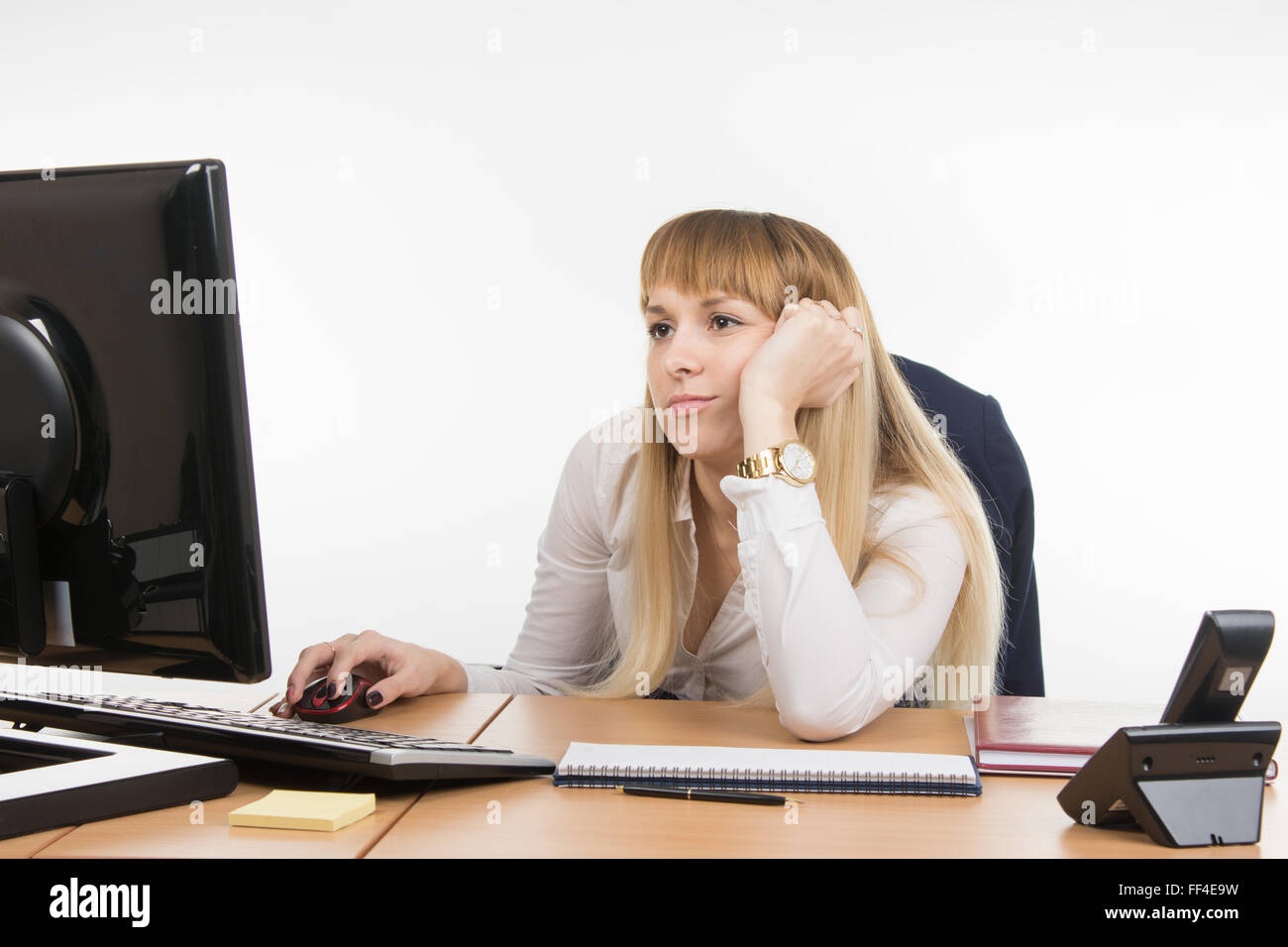 Office worker looking blankly at the computer screen in the office ...