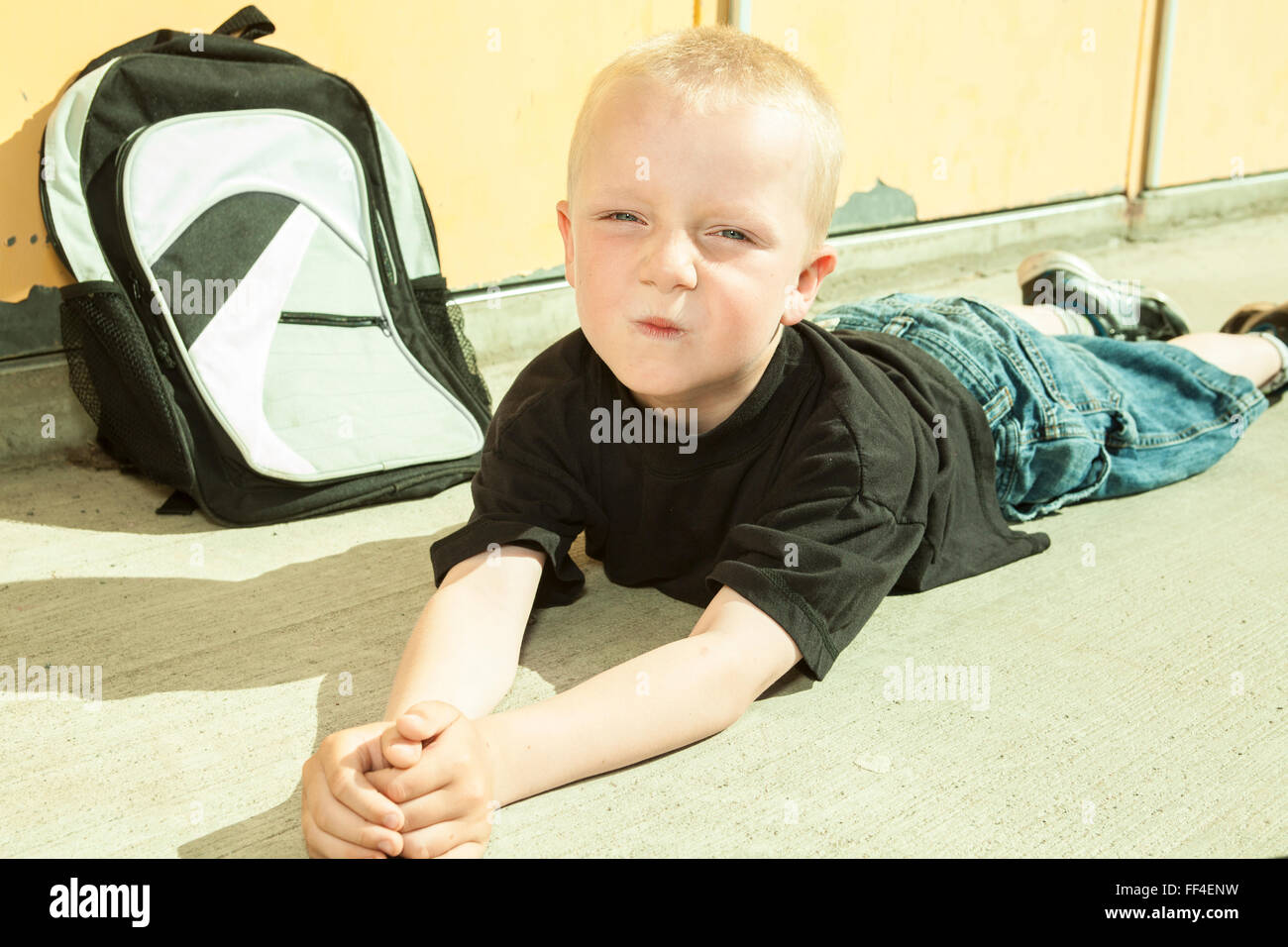 A very sad boy in school playground Stock Photo - Alamy