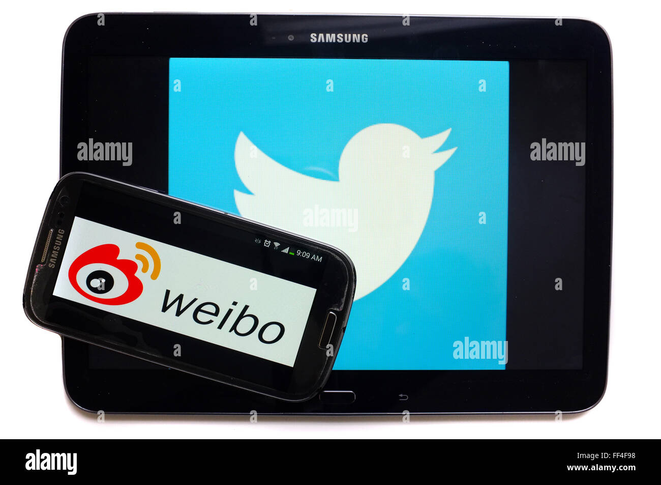 The Weibo logo on a smartphone and Twitter on a tablet photographed ...