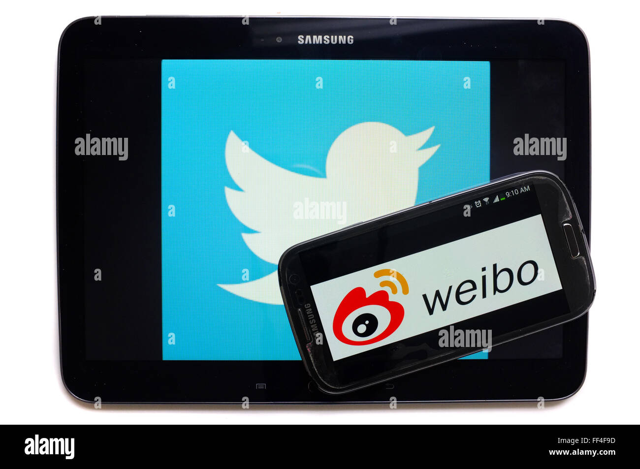 The Weibo logo on a smartphone and Twitter on a tablet photographed ...