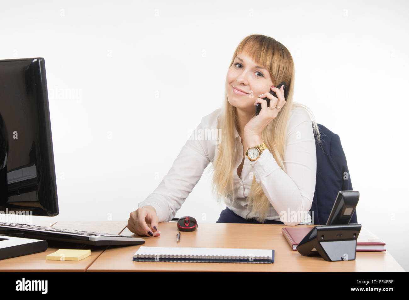 Office Specialist talking on a cell phone in the workplace Stock Photo ...