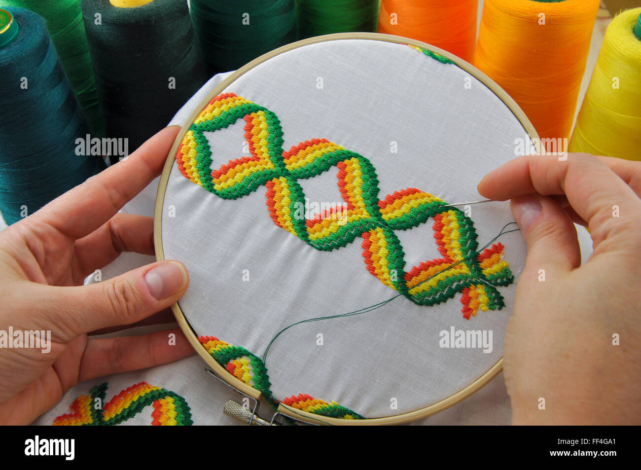 Colorful geometric pattern embroidered in the hoop on a background ...