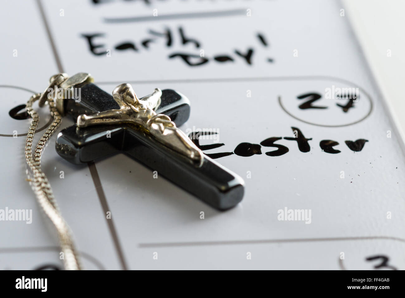 religious cross on a calendar on the date March 27 for a concept for ...
