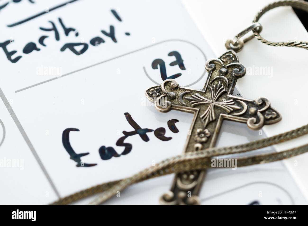 religious cross on a calendar on the date March 27 for a concept for ...