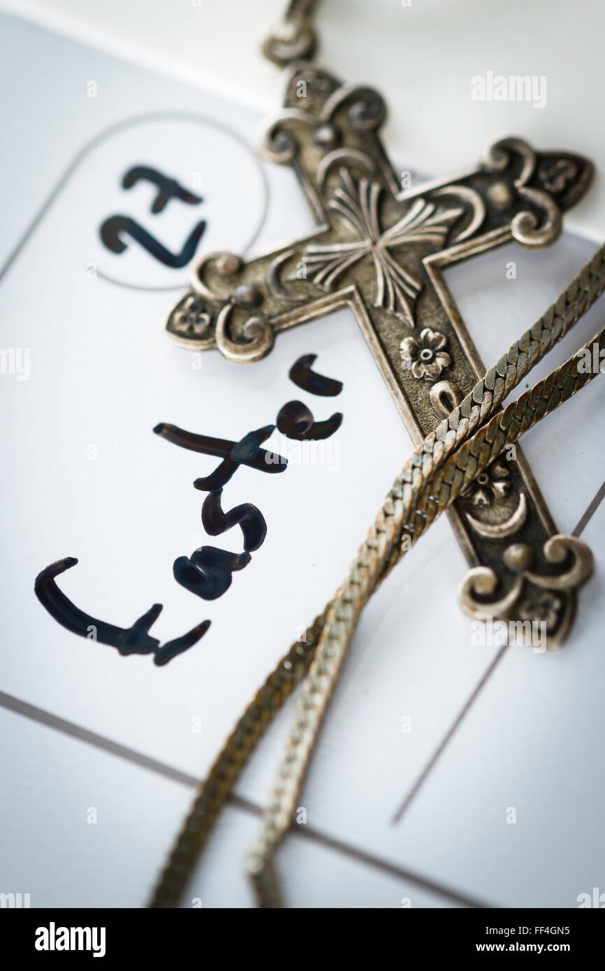 religious cross on a calendar on the date March 27 for a concept for ...