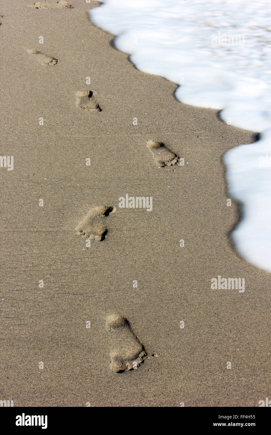 Footsteps on a beach Stock Photo - Alamy