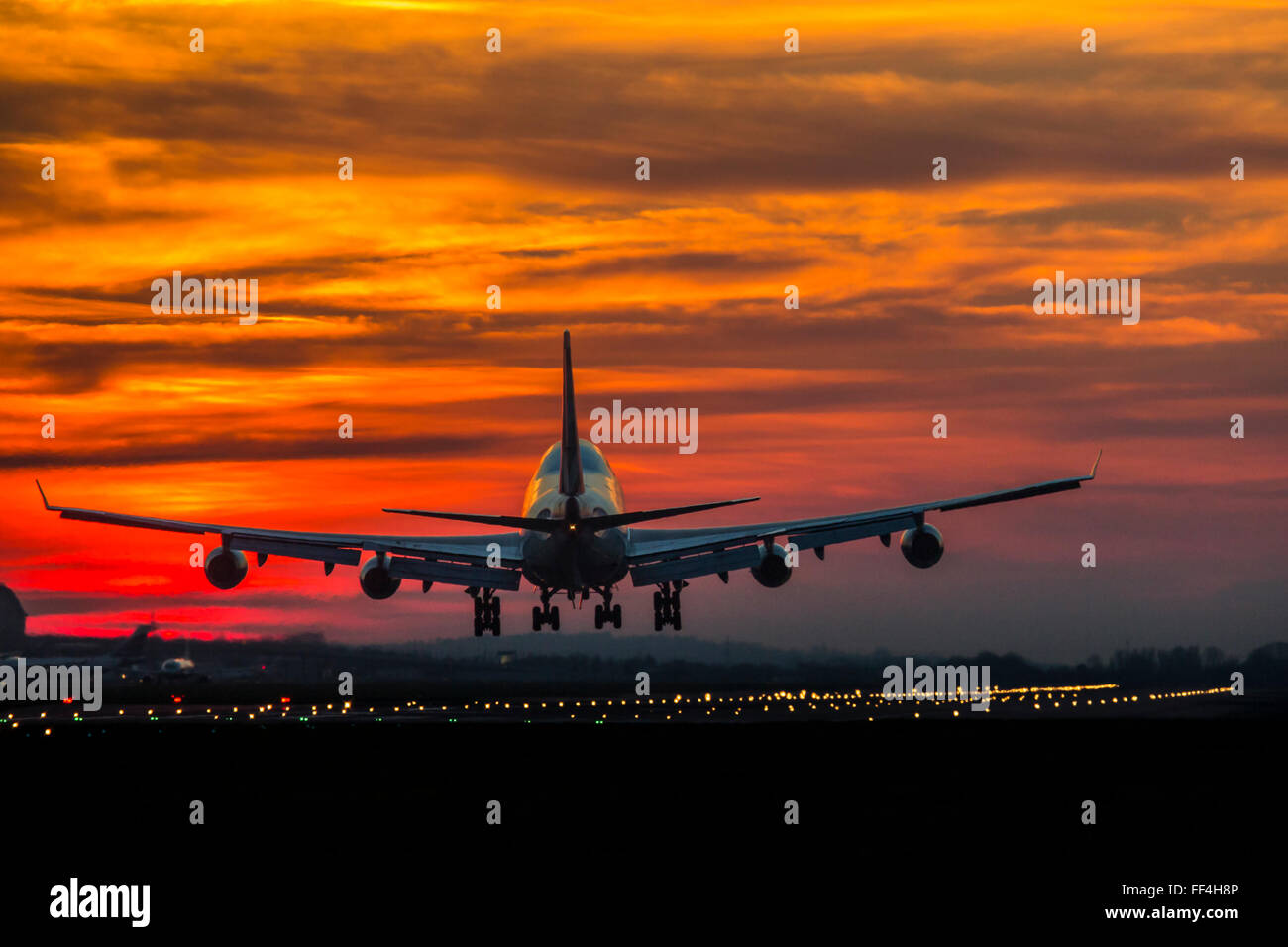 Plane Landing At Sunset