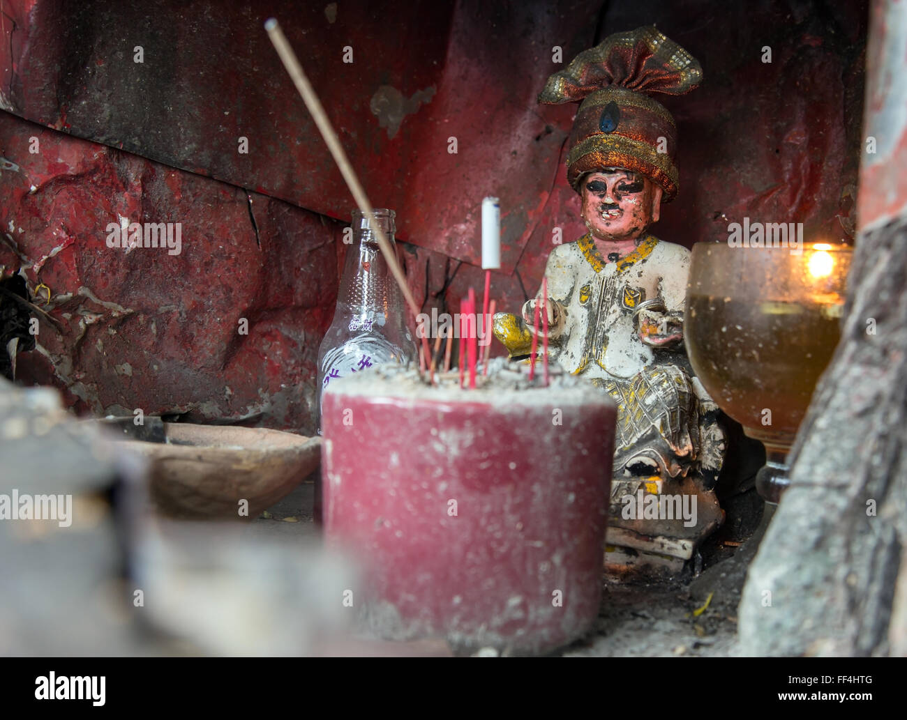 statue of a Buddhist Ghost God inside roots of tree Stock Photo - Alamy