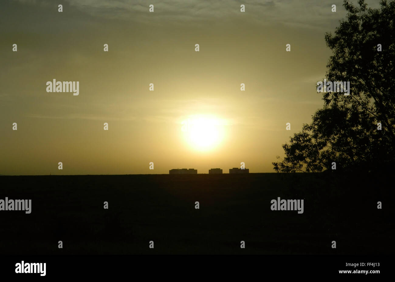 sunset over the border between city and nature Stock Photo - Alamy
