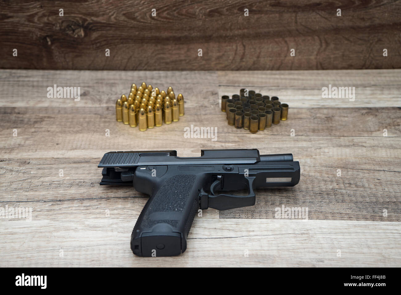 Gun pistol with new and used bullets on wooden background Stock Photo ...