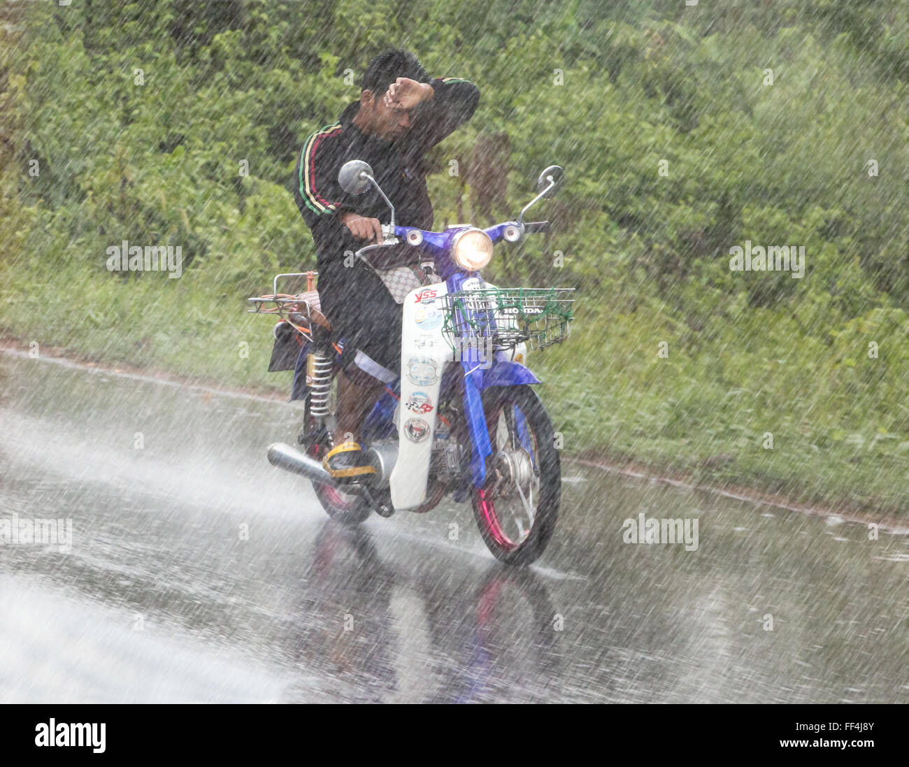 motorbike on the road in rain Stock Photo - Alamy