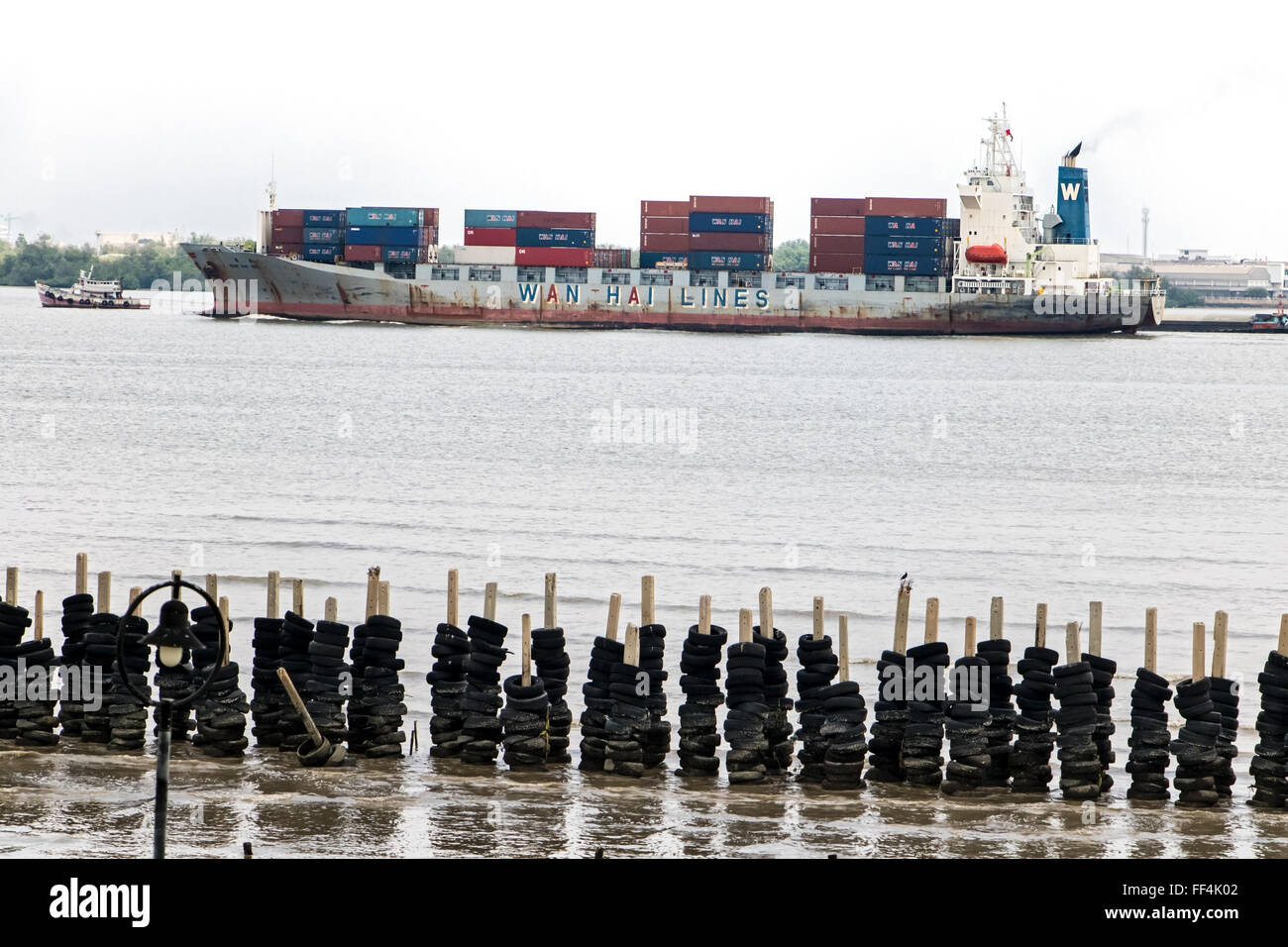 Cargo container ship company Wan Hai Lines LTD sailing down the river ...