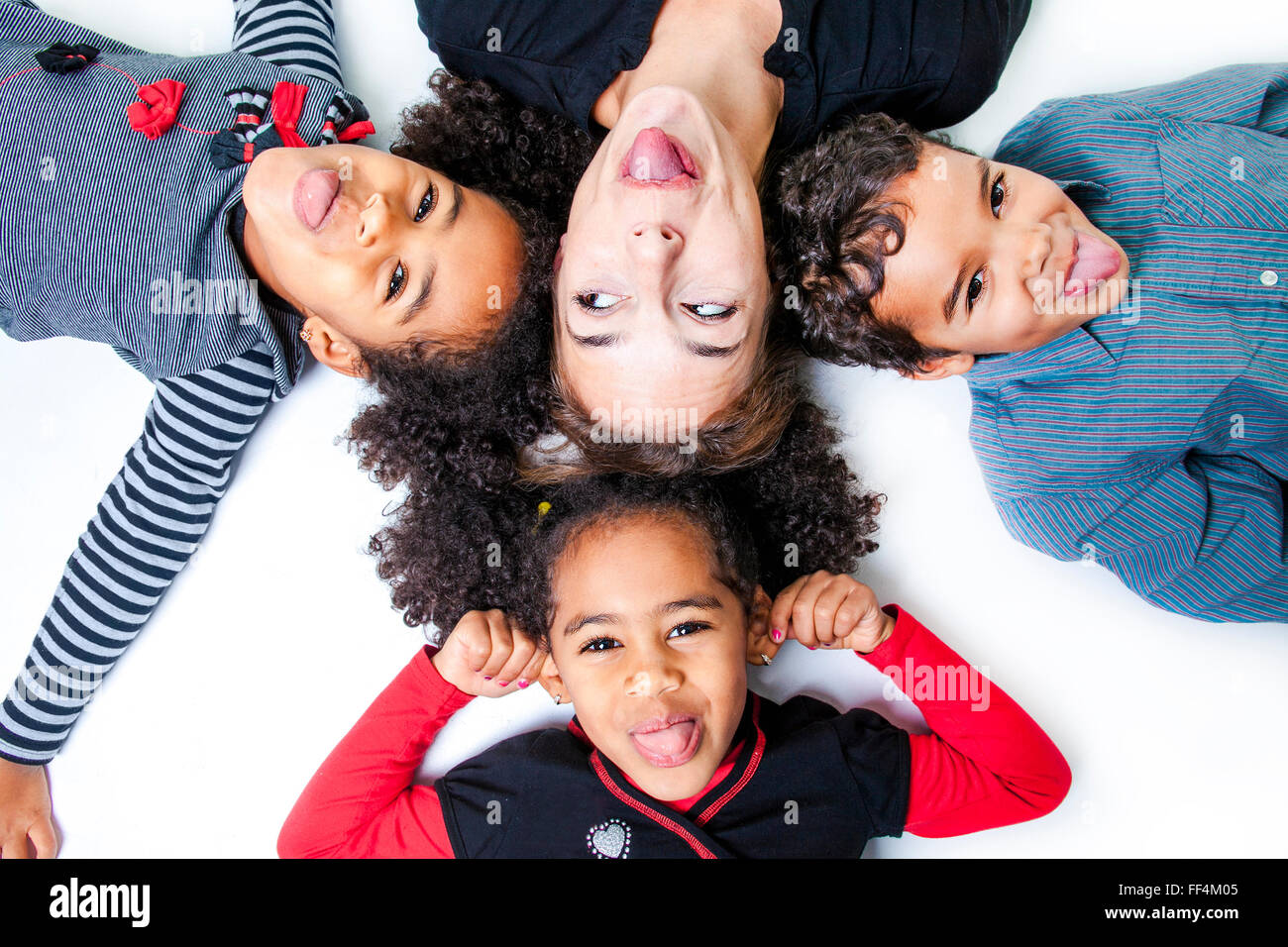 A family lay on the floor of a photography studio Stock Photo - Alamy