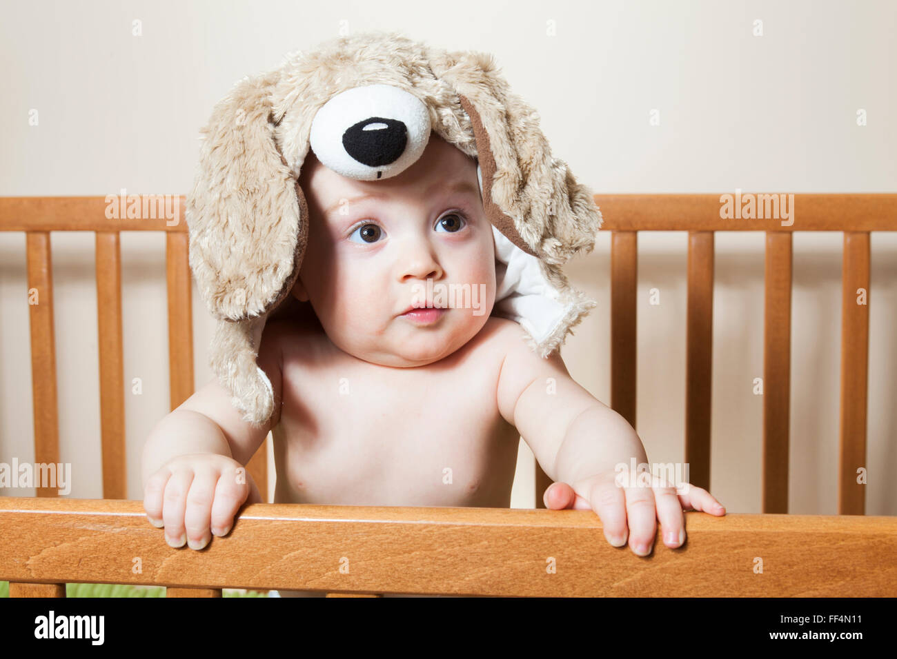 Funny little baby with beautiful standing in a round white crib Stock ...