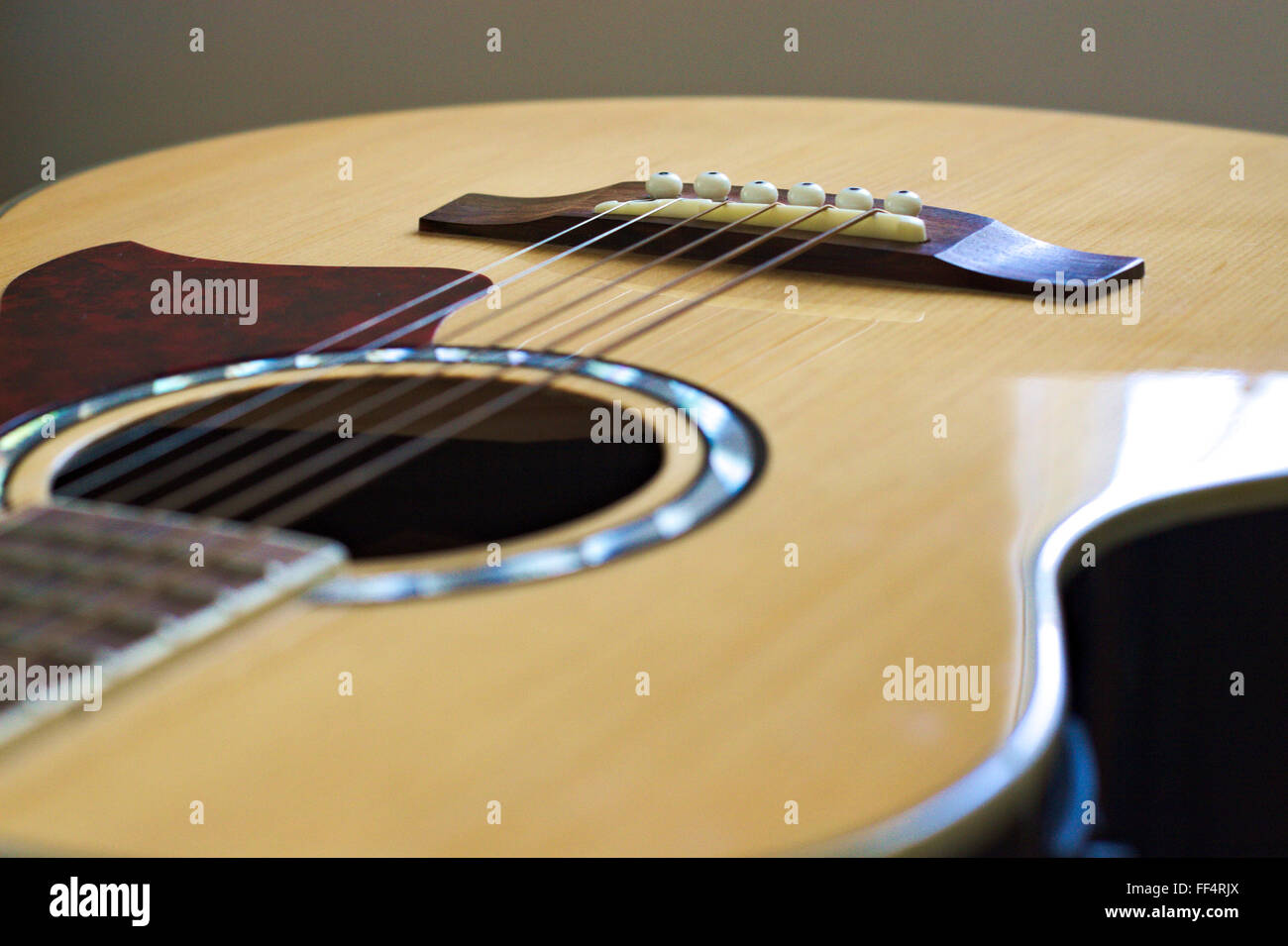 Looking over the sound hole and strings of an electric acoustic guitar ...