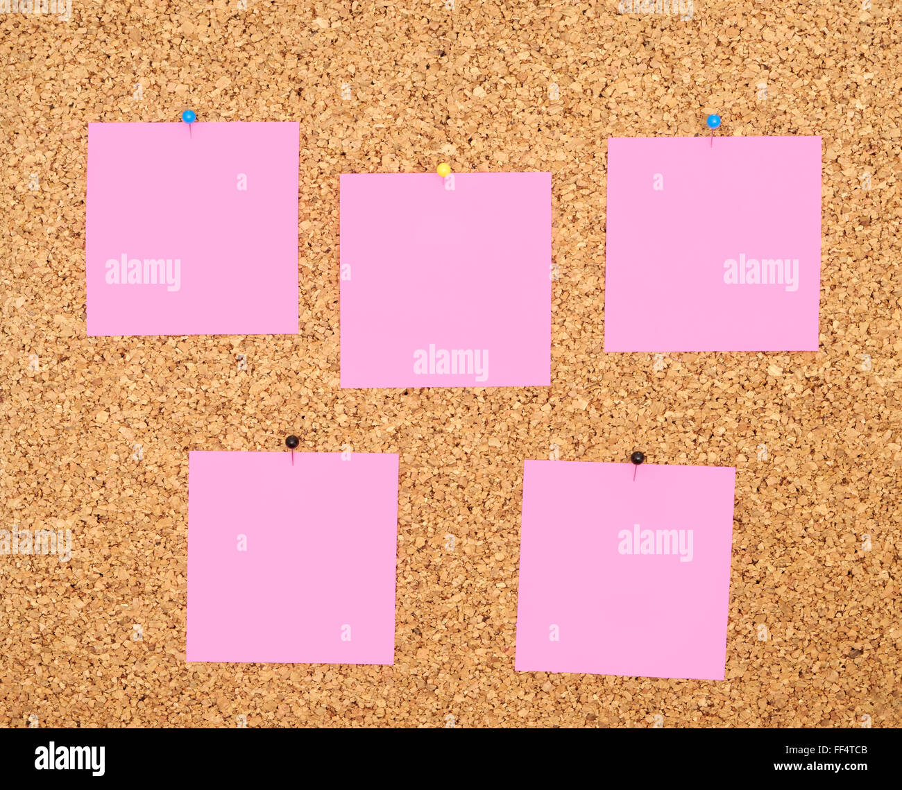 Pink sticker notes over cork board background Stock Photo - Alamy