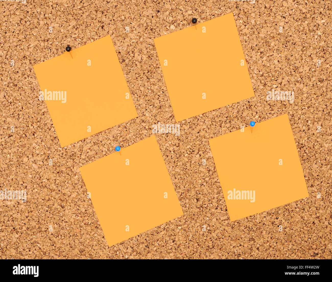 Orange sticker notes over cork board background Stock Photo - Alamy