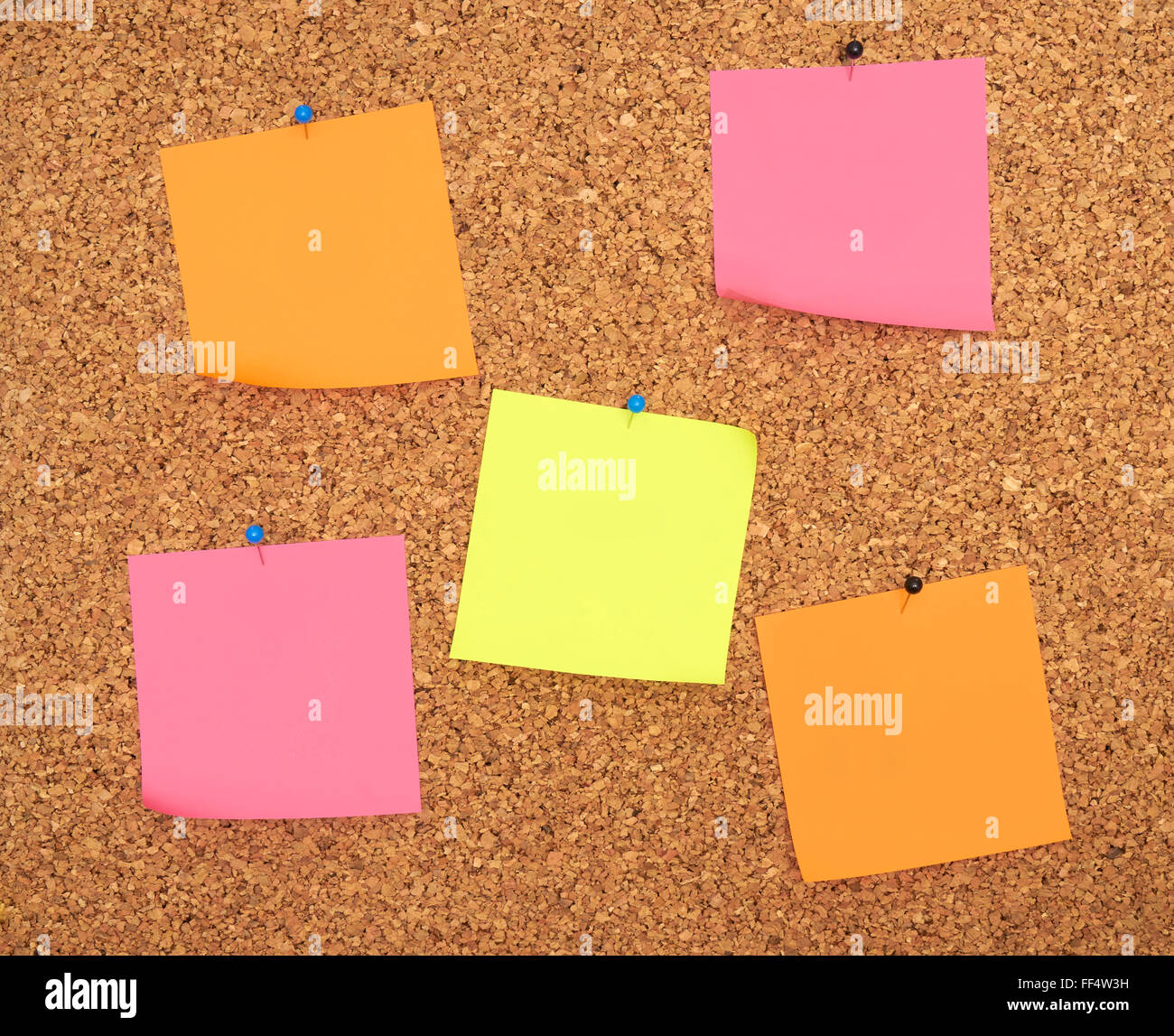 Color sticker notes over cork board background Stock Photo - Alamy