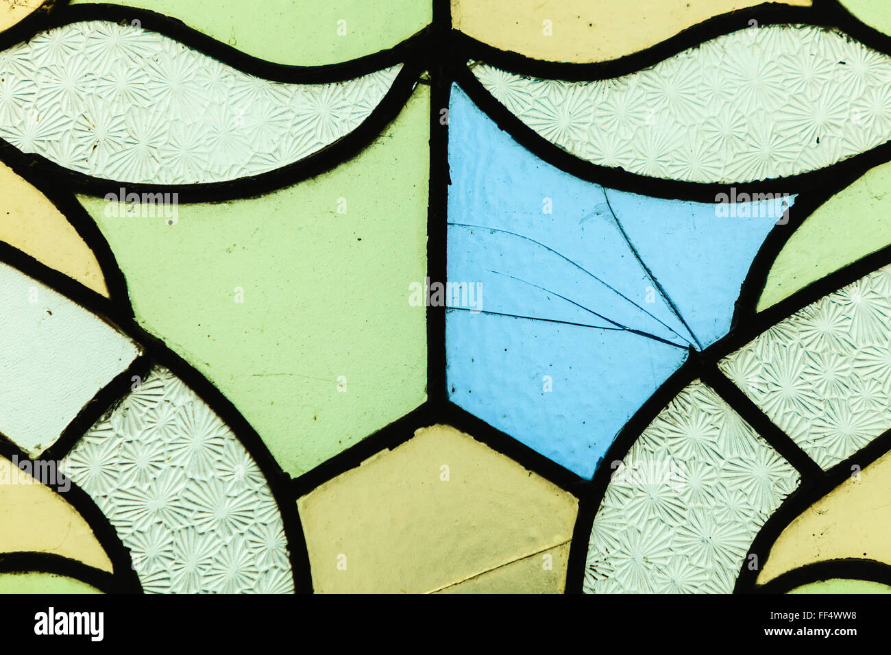multicolored stained glass window with irregular block pattern in hue ...