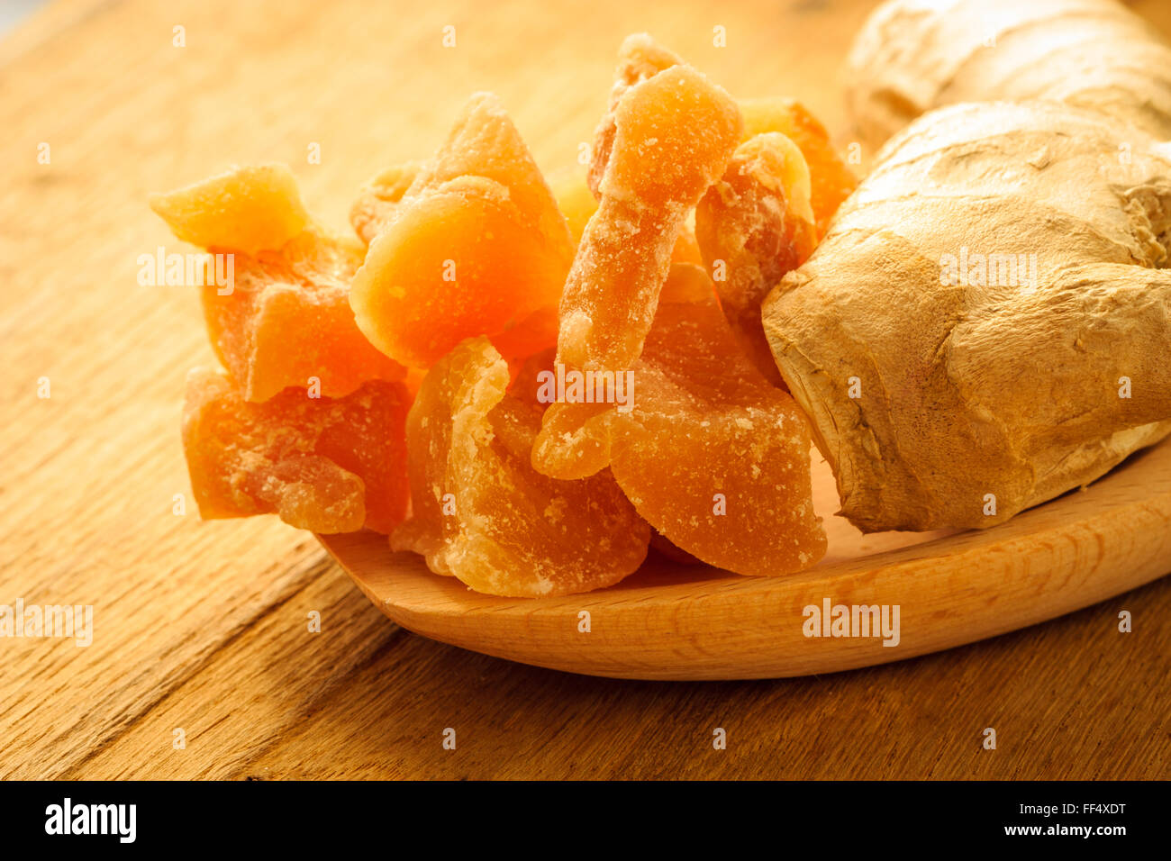 Closeup dried candied crystallized ginger pieces and fresh root on ...