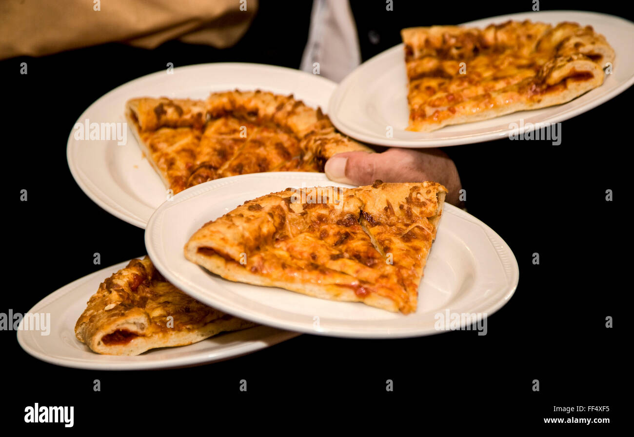 Plates of pizza wedges Stock Photo - Alamy