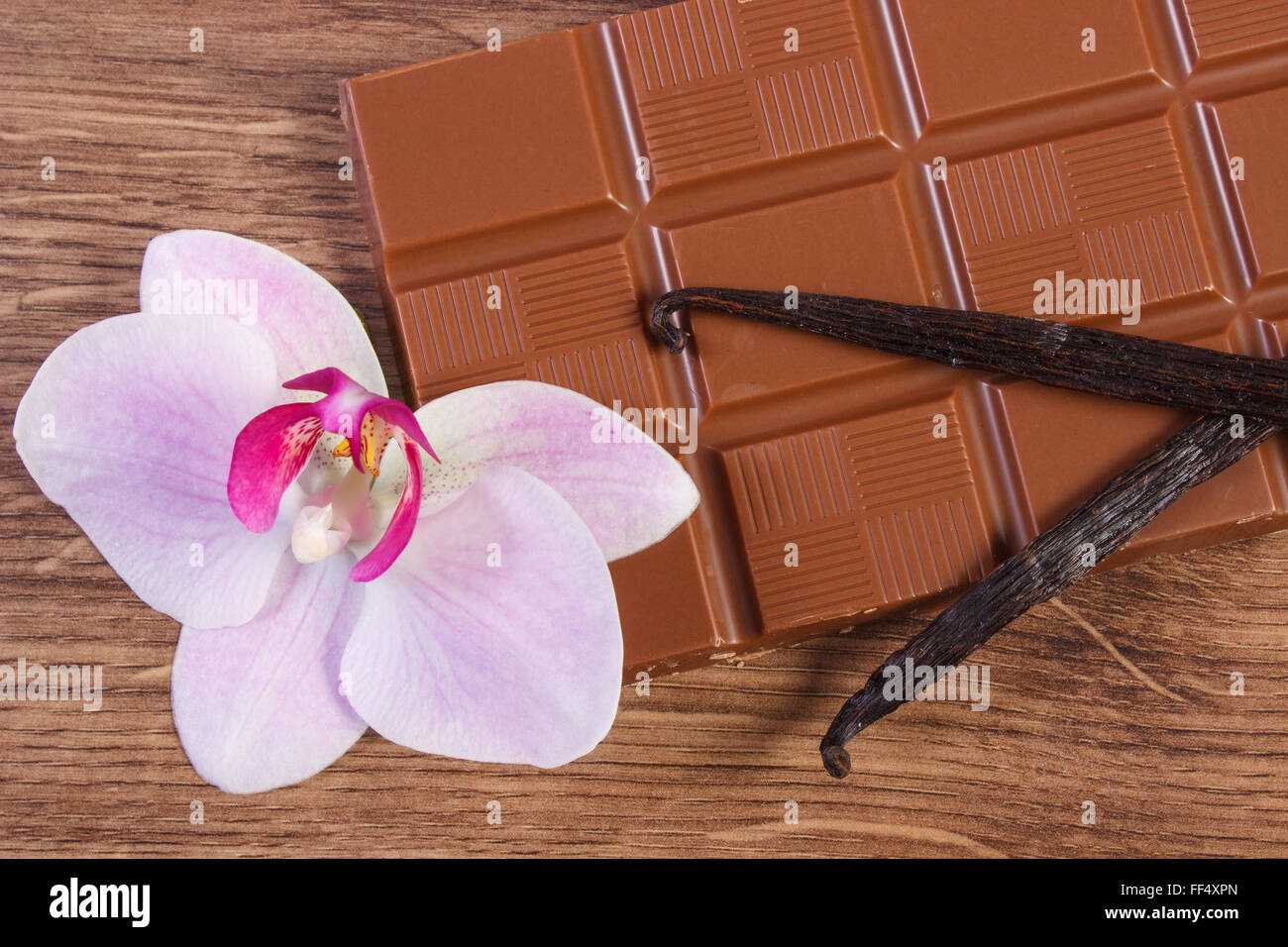 Portion of milk chocolate, fresh fragrant vanilla sticks pods and ...