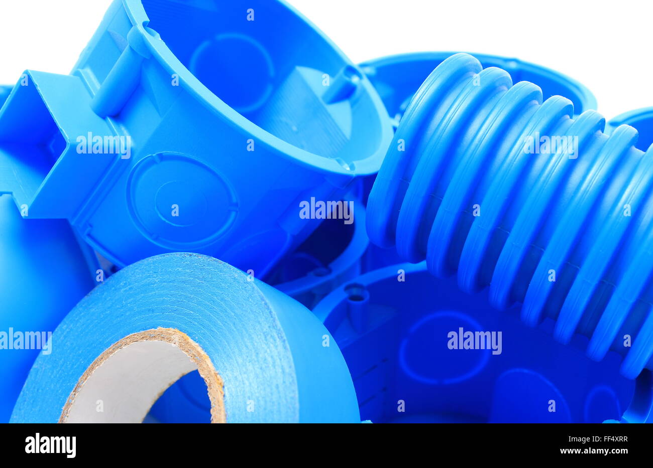 Heap of blue electrical boxes and components for use in electrical ...