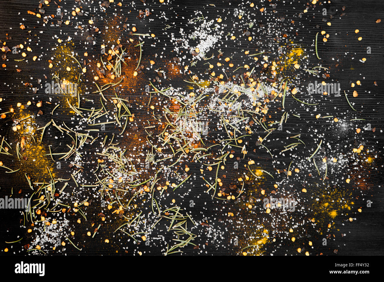 Close up rub and marinade powder and sauce scattered on black ...