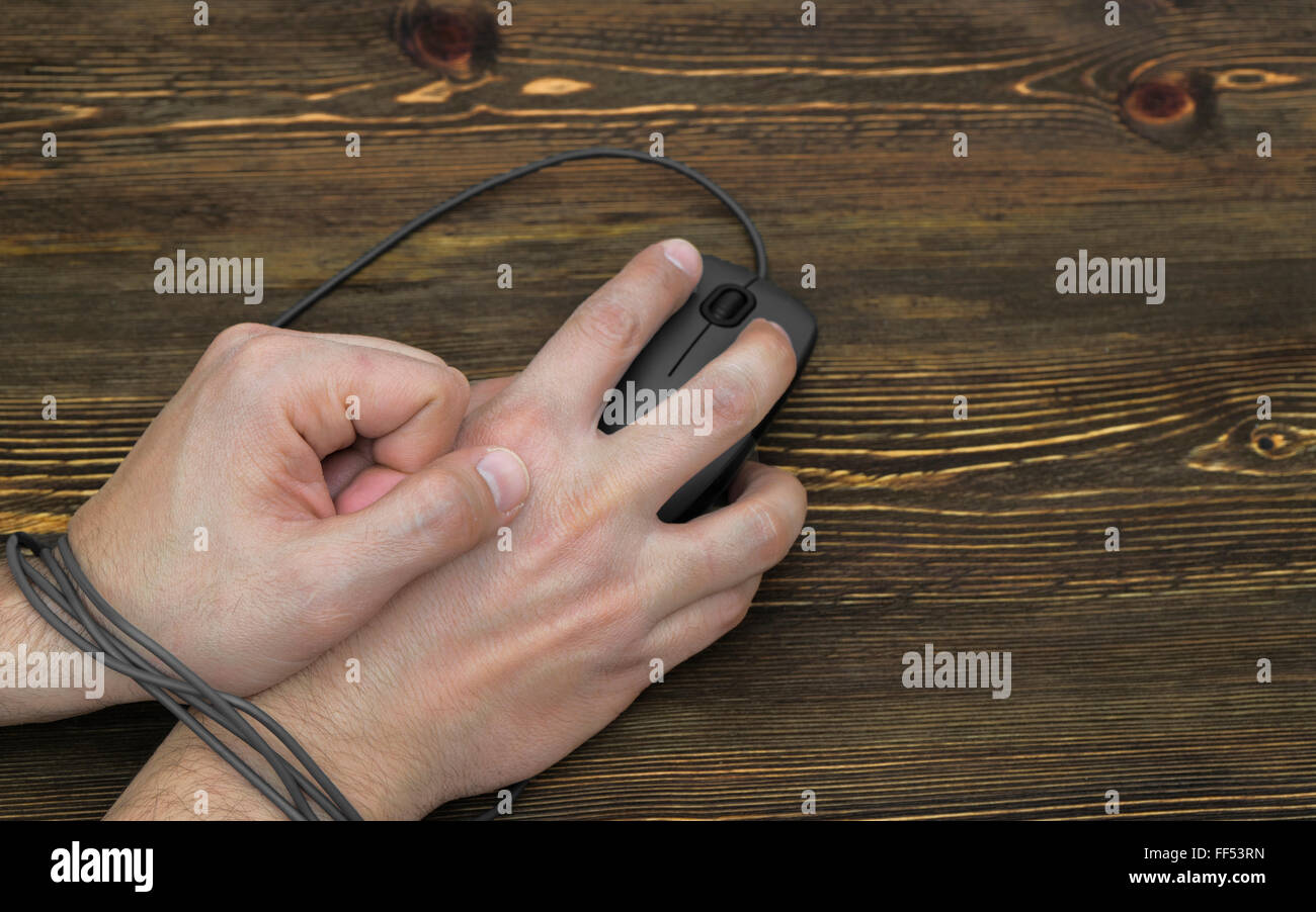 Bound wrist by computer mouse cable, on black background Stock Photo ...