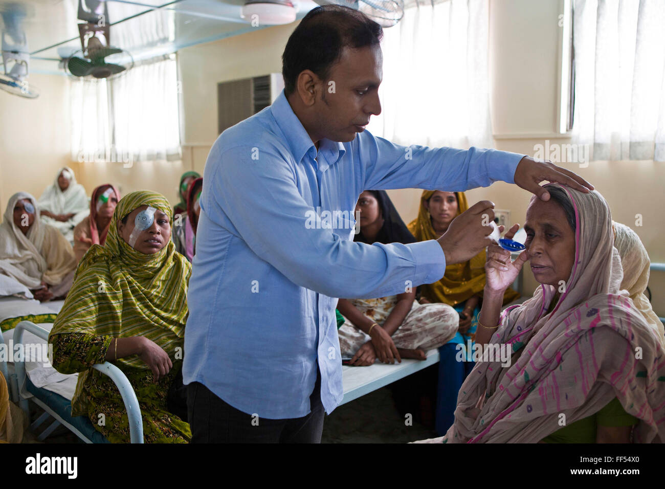 Dr Mohamed Shaheen performs an eye examination on a patient after ...