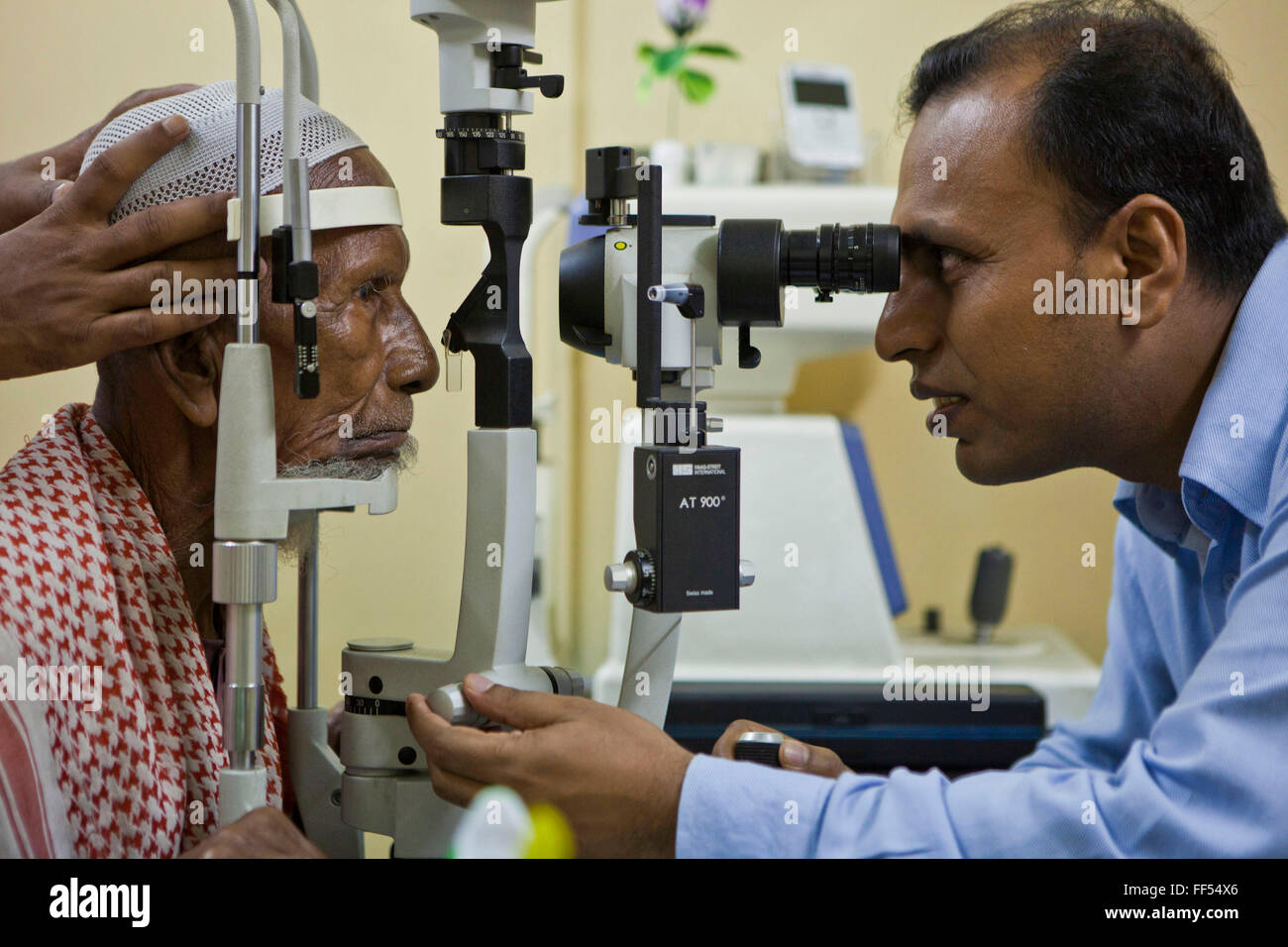 Dr Mohamed Shaheen performs an eye examination on a patient after ...