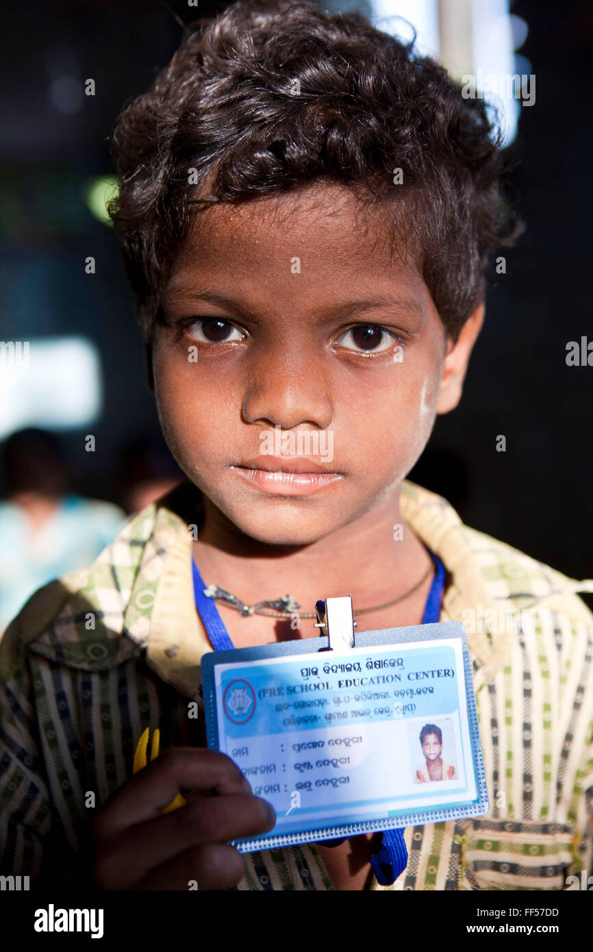 A young boy with his school identity card organised by CLAP, Committee ...