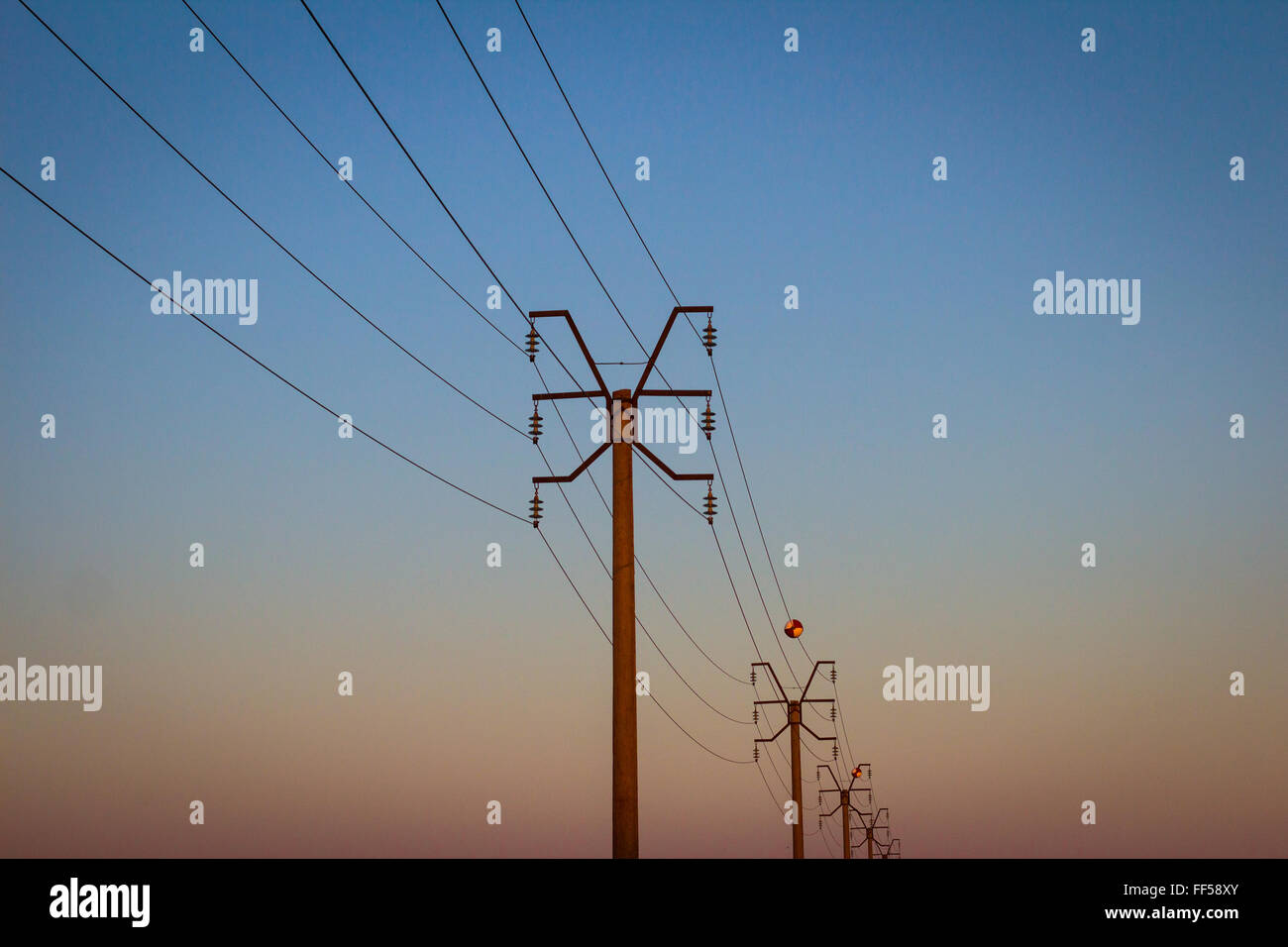 Electrical poles and wires at sunset Stock Photo - Alamy