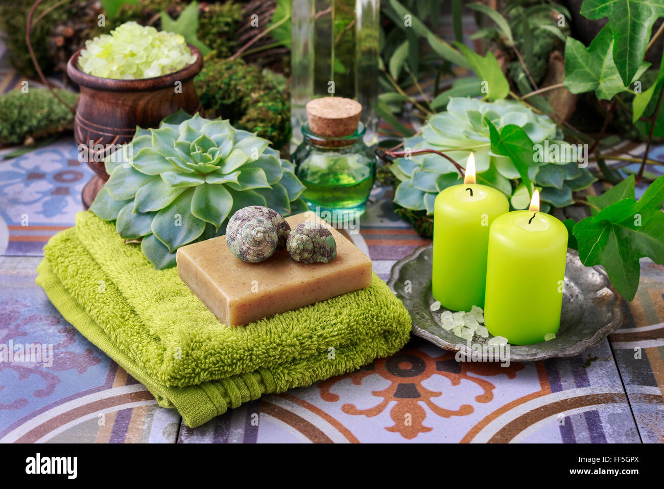 Spa cosmetics: sea salt, bottle of essential oil, bar of handmade soap ...