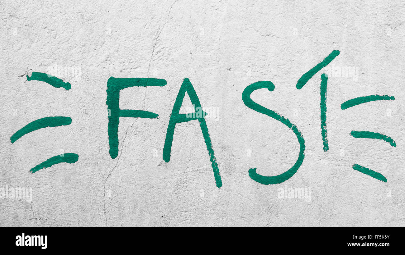 Message "Fast" written on the wall with green spray paint Stock Photo ...