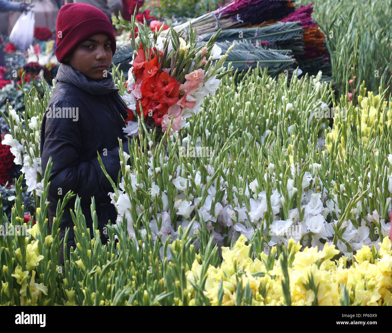 Pakistani flower vendor display fresh roses and garlands to attract the ...