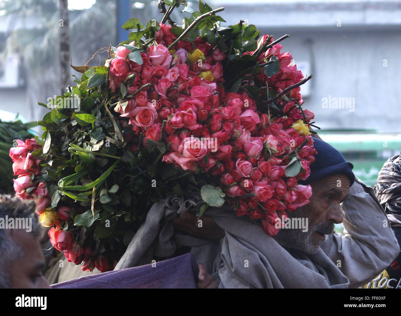 Pakistani flower vendor display fresh roses and garlands to attract the ...