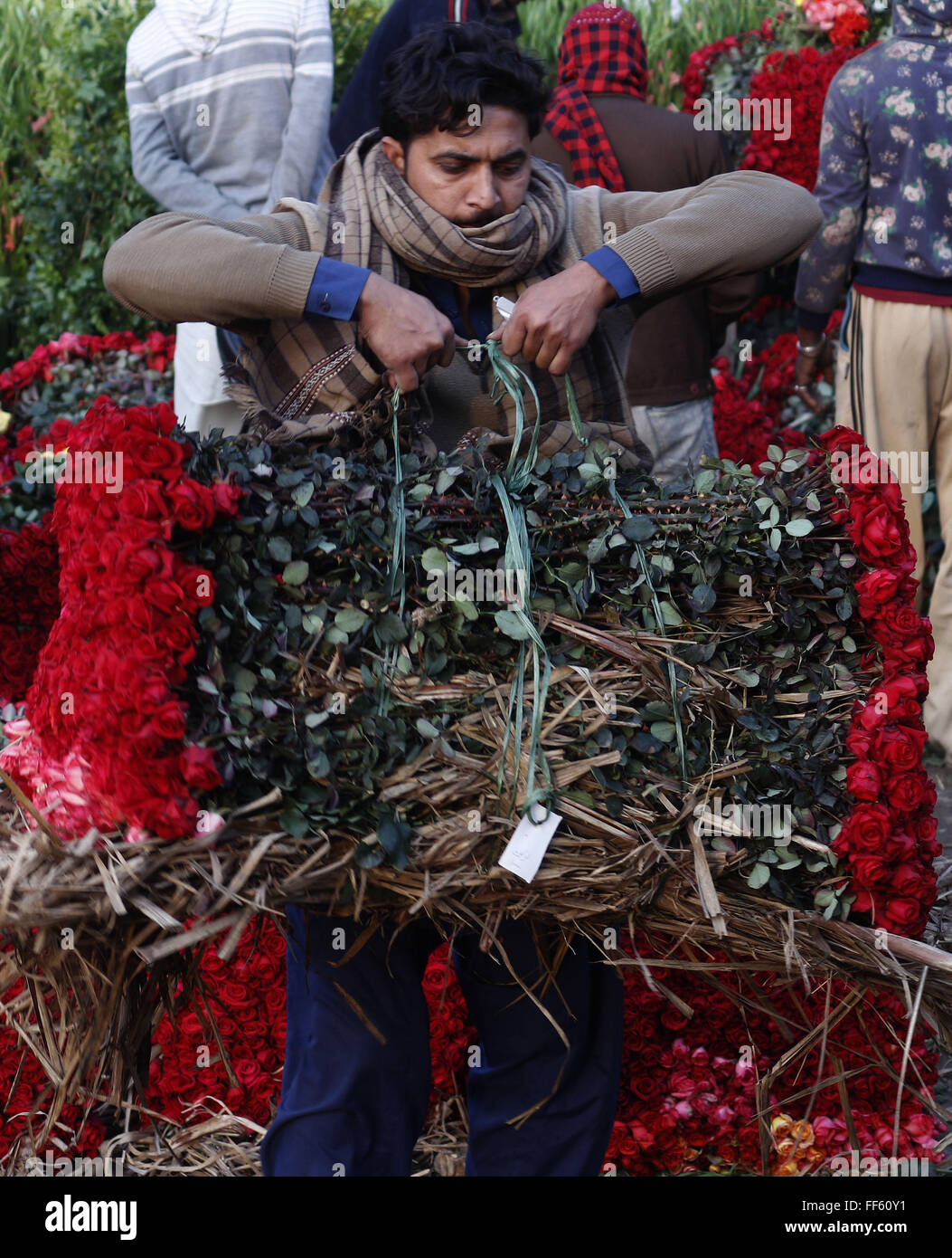 Pakistani flower vendor display fresh roses and garlands to attract the ...