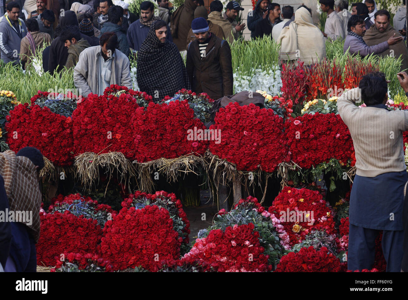 Pakistani flower vendor display fresh roses and garlands to attract the ...