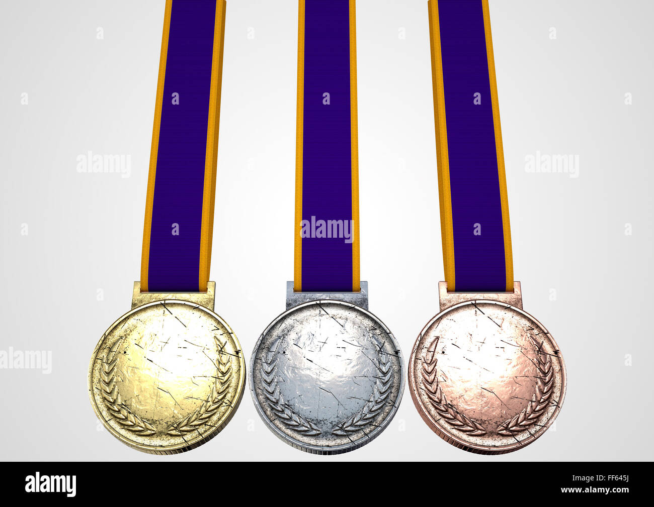 A set of blank gold, silver and bronze medals with ribbons on an ...