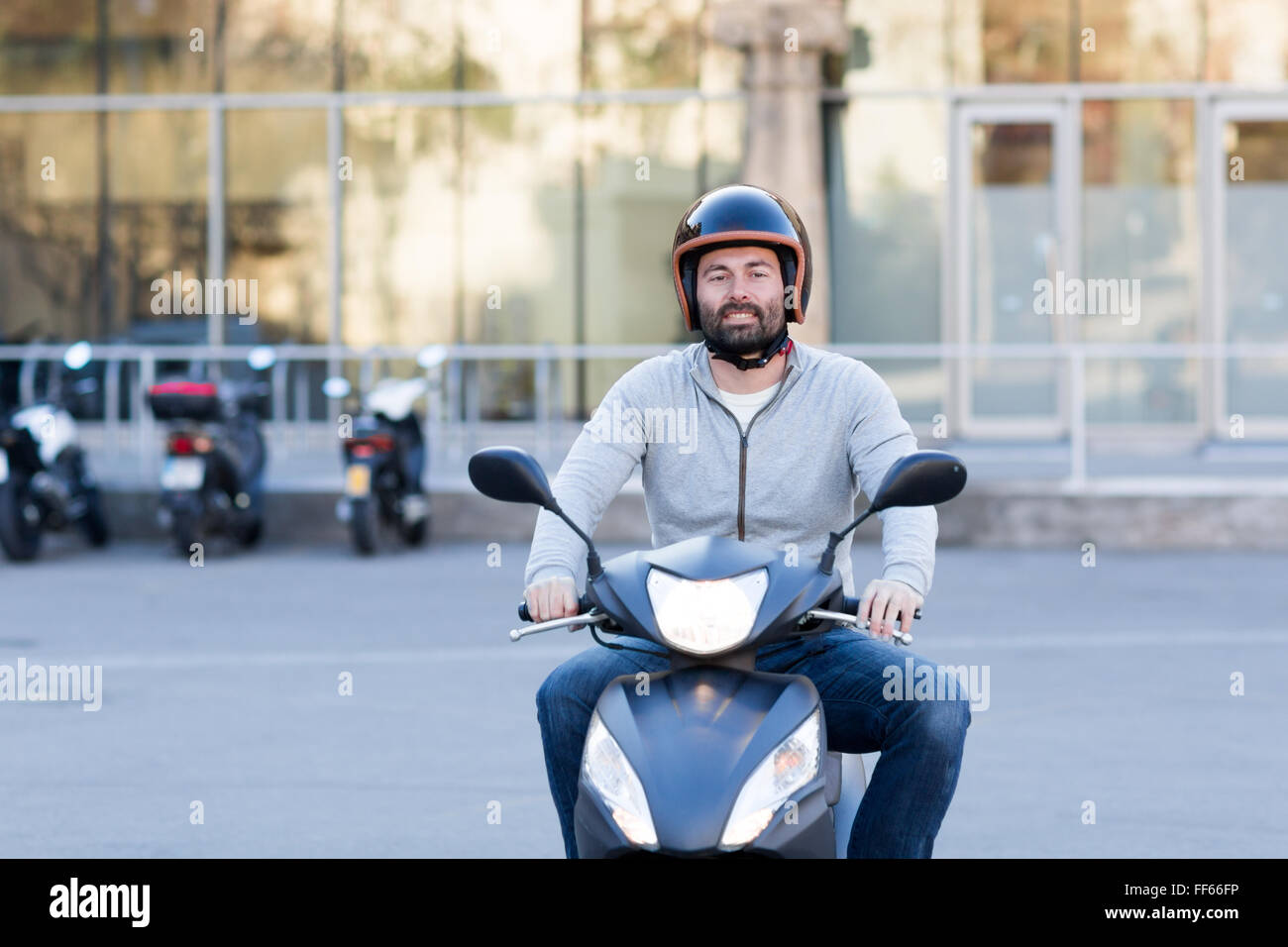Man driving a scooter Stock Photo - Alamy