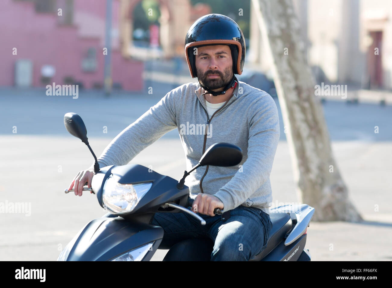 Man driving a scooter Stock Photo - Alamy
