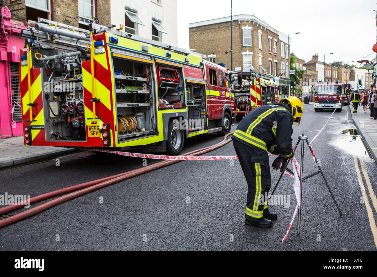 A London Fire Brigade firefighter seals off an emergency area with ...