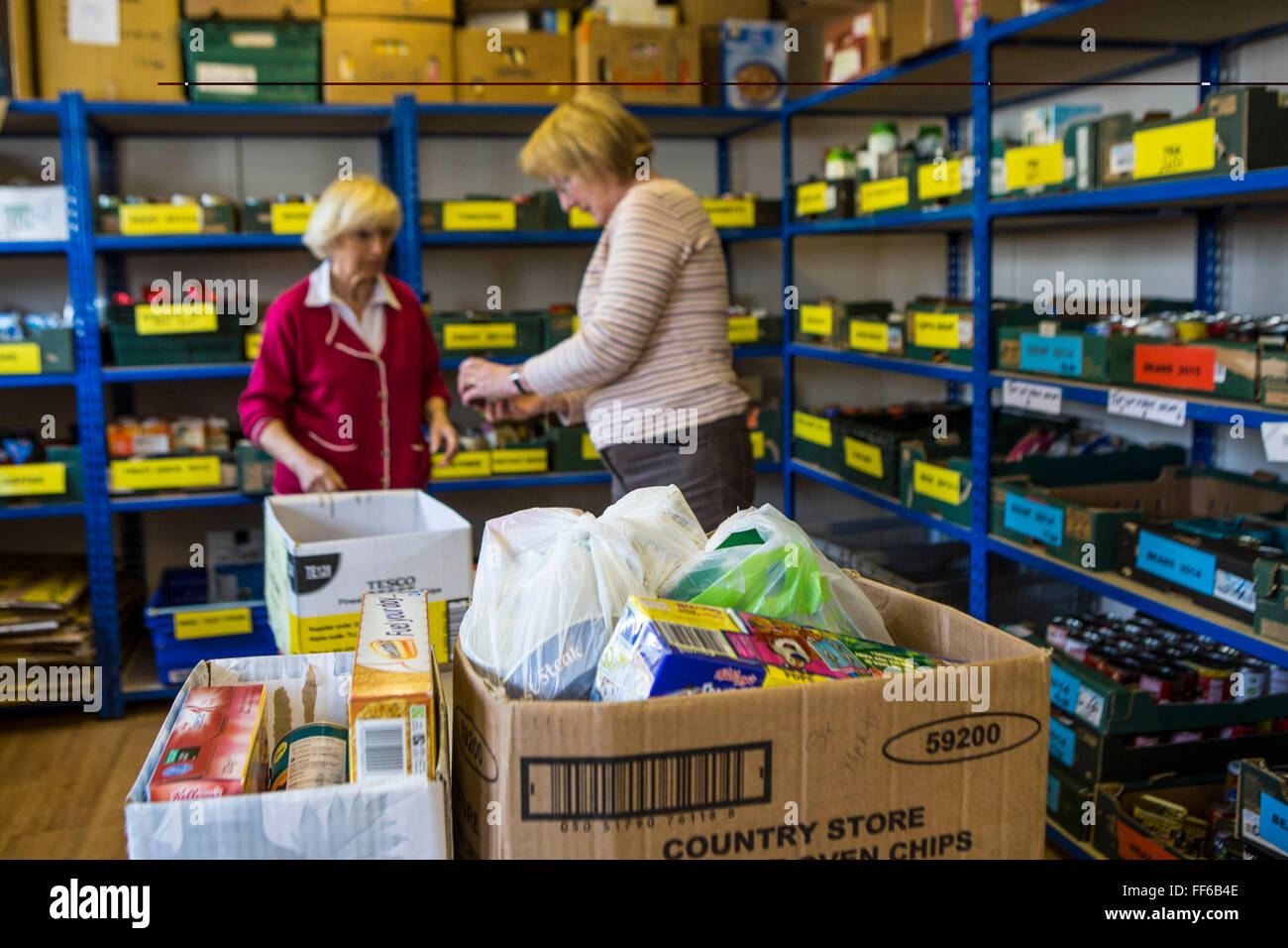Two female volunteers prepare an emergency food package at Wadebridge ...