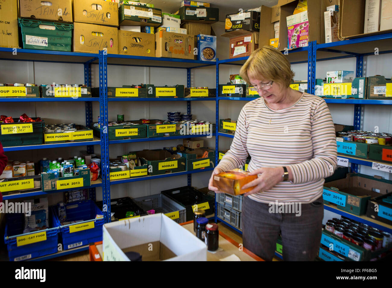 A female volunteer prepares an emergency food package at Wadebridge ...
