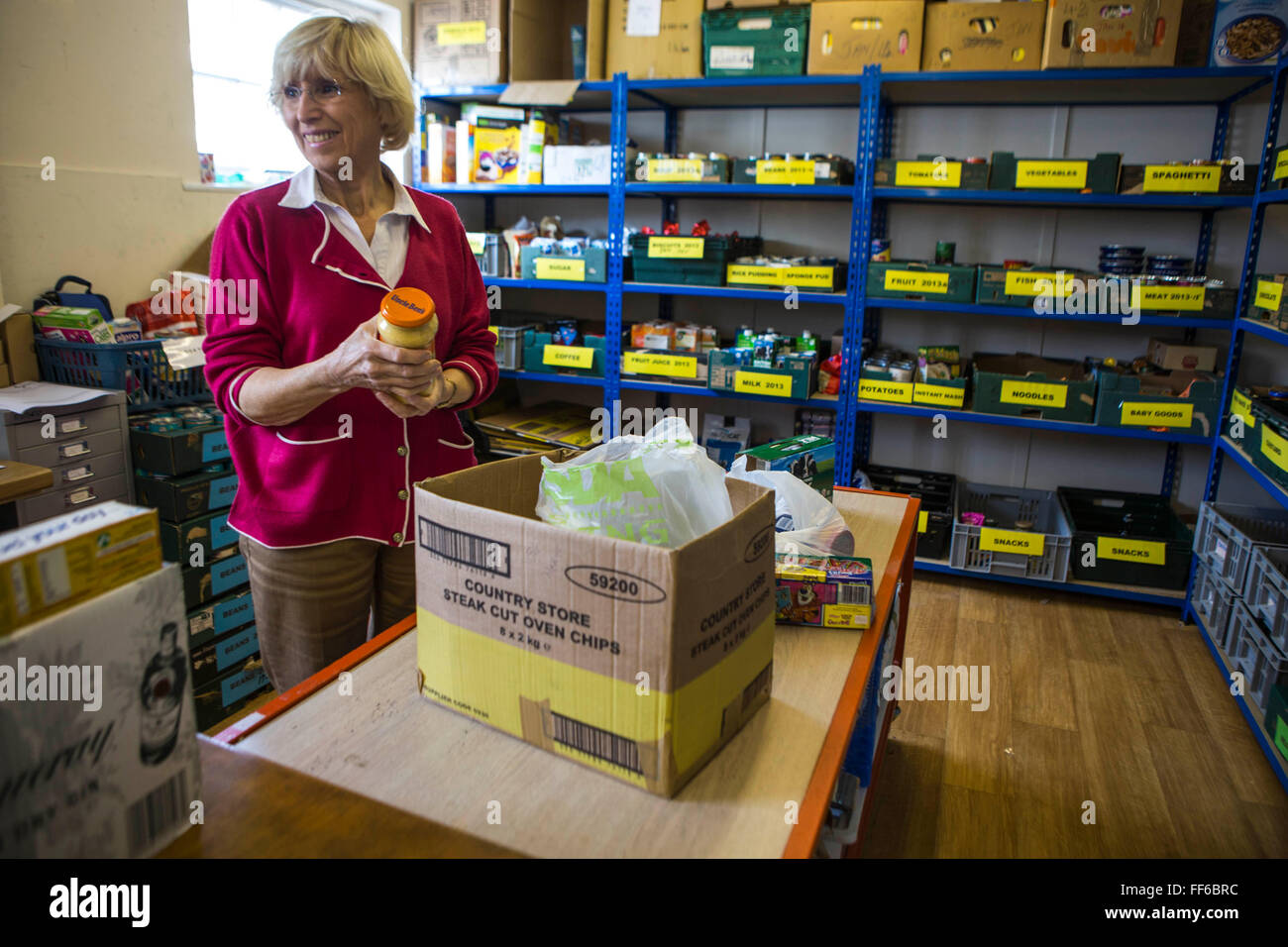 A female volunteer prepares an emergency food package at Wadebridge ...