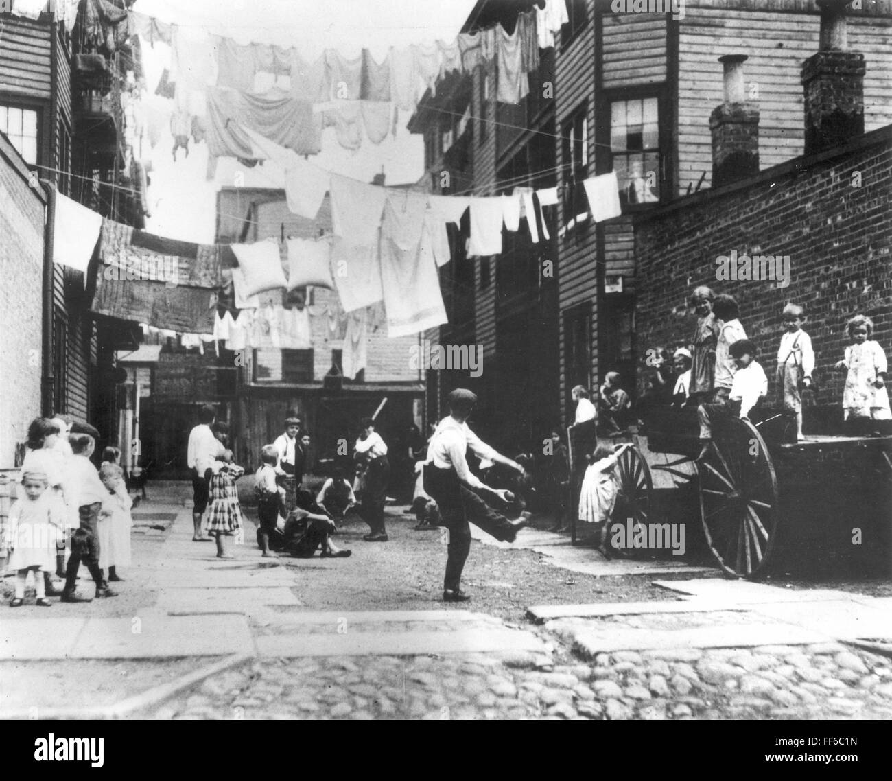 LOWER EAST SIDE, NYC, c1910. /nChildren using a tenement alley for a ...